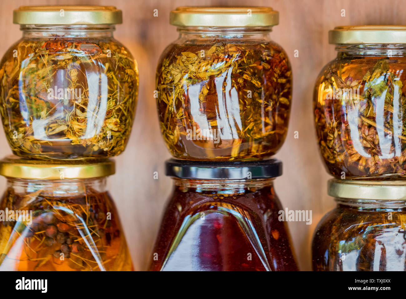 Jars with honey and natural colorful herbs for sale on shelves Stock ...