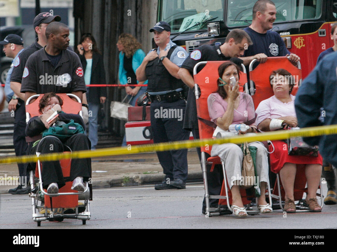 Emergency responders triage injured commuters after a Chicago Transit ...
