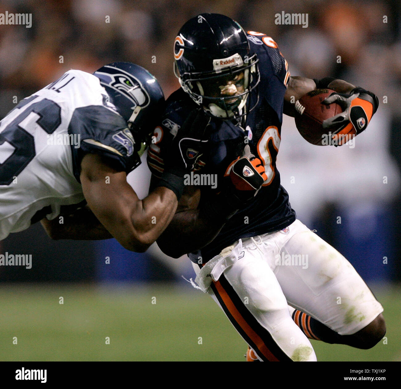 Chicago Bears running back Thomas Jones, right, is tackled by Seattle ...