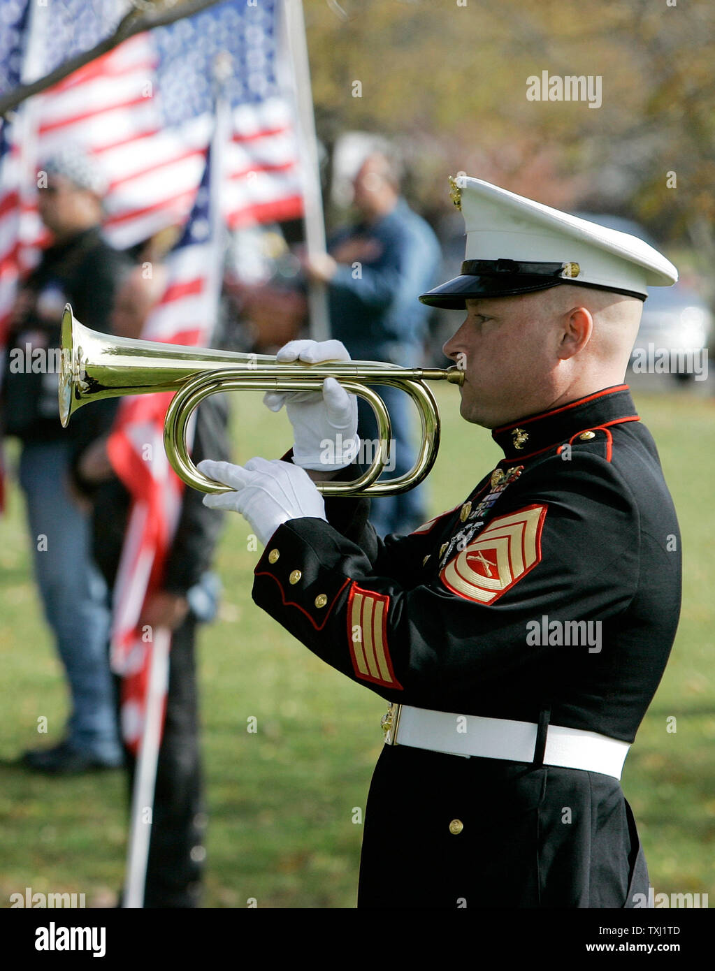A Marine plays taps for Lance Corporal Edwardo Lopez during his funeral ...