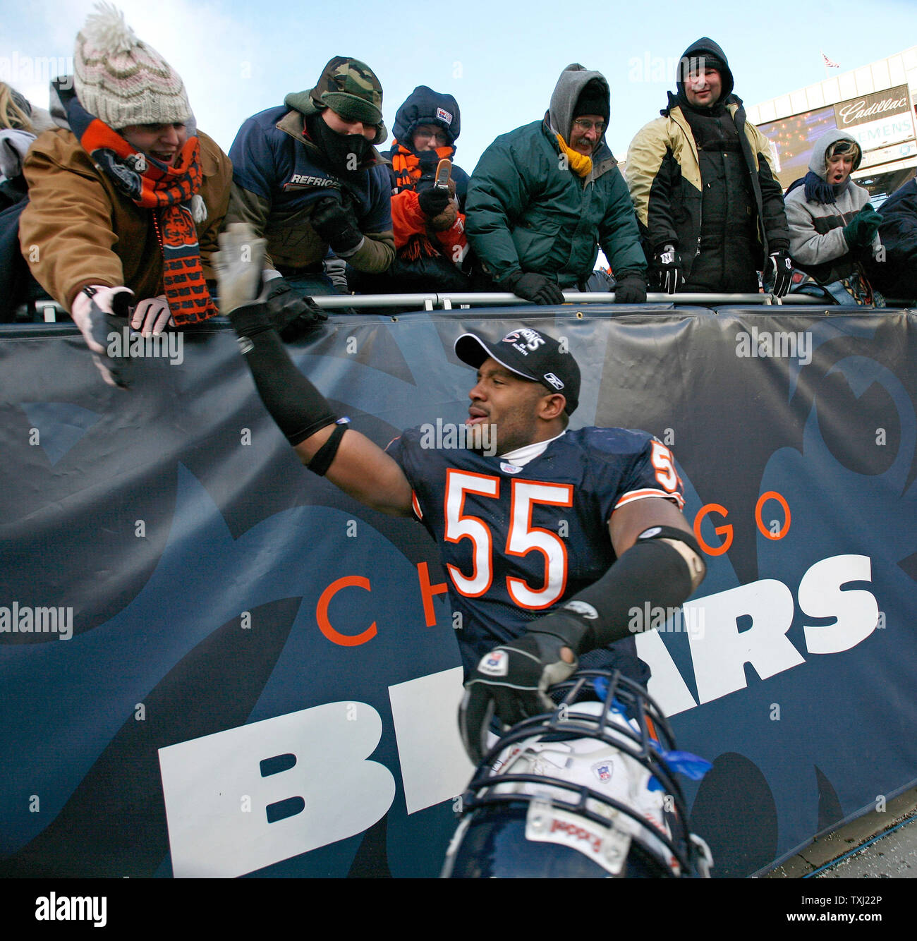 Chicago Bears linebacker Lance Briggs high-fives fans as he celebrates ...