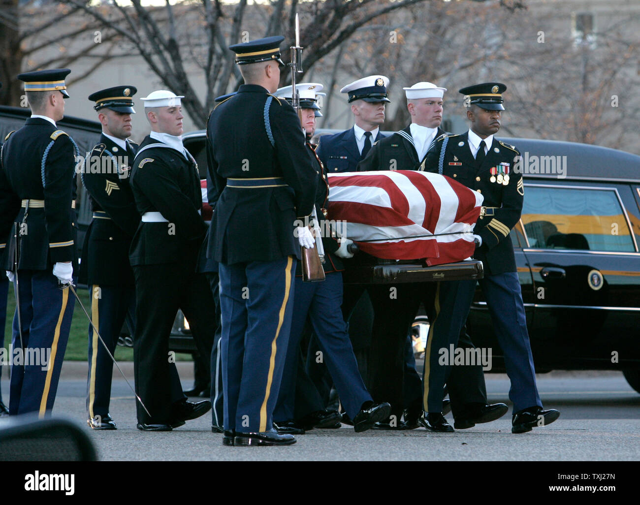 A military honor guard carries the casket of 38th President Gerald Ford ...