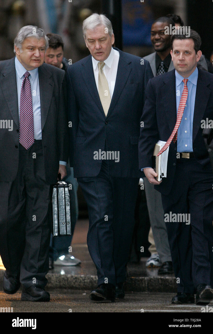 Former Hollinger International CEO Conrad Black, center, walks with his ...