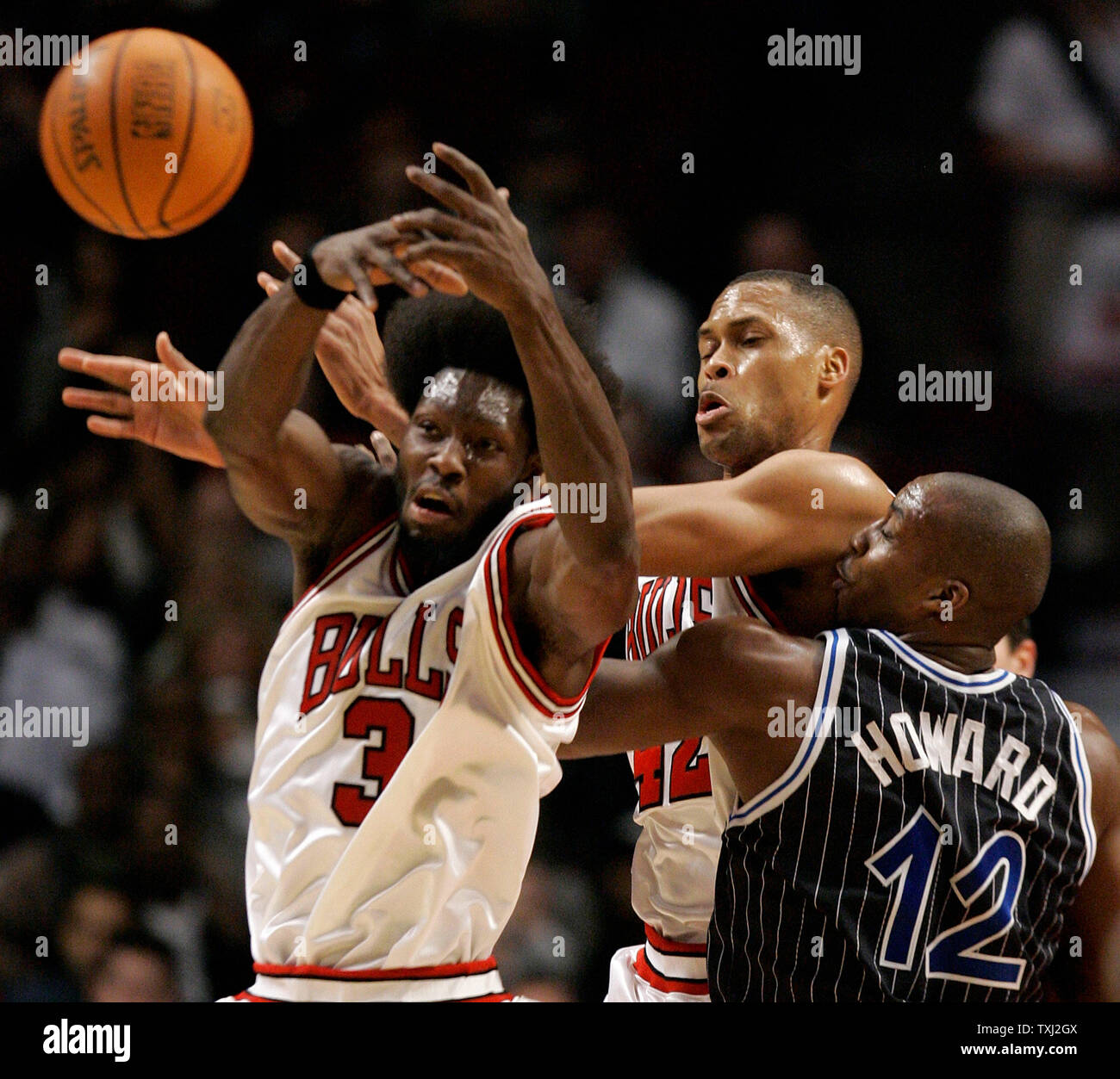 Chicago Bulls' Ben Wallace (3), P.J. Brown, center, and Orlando Magic's ...