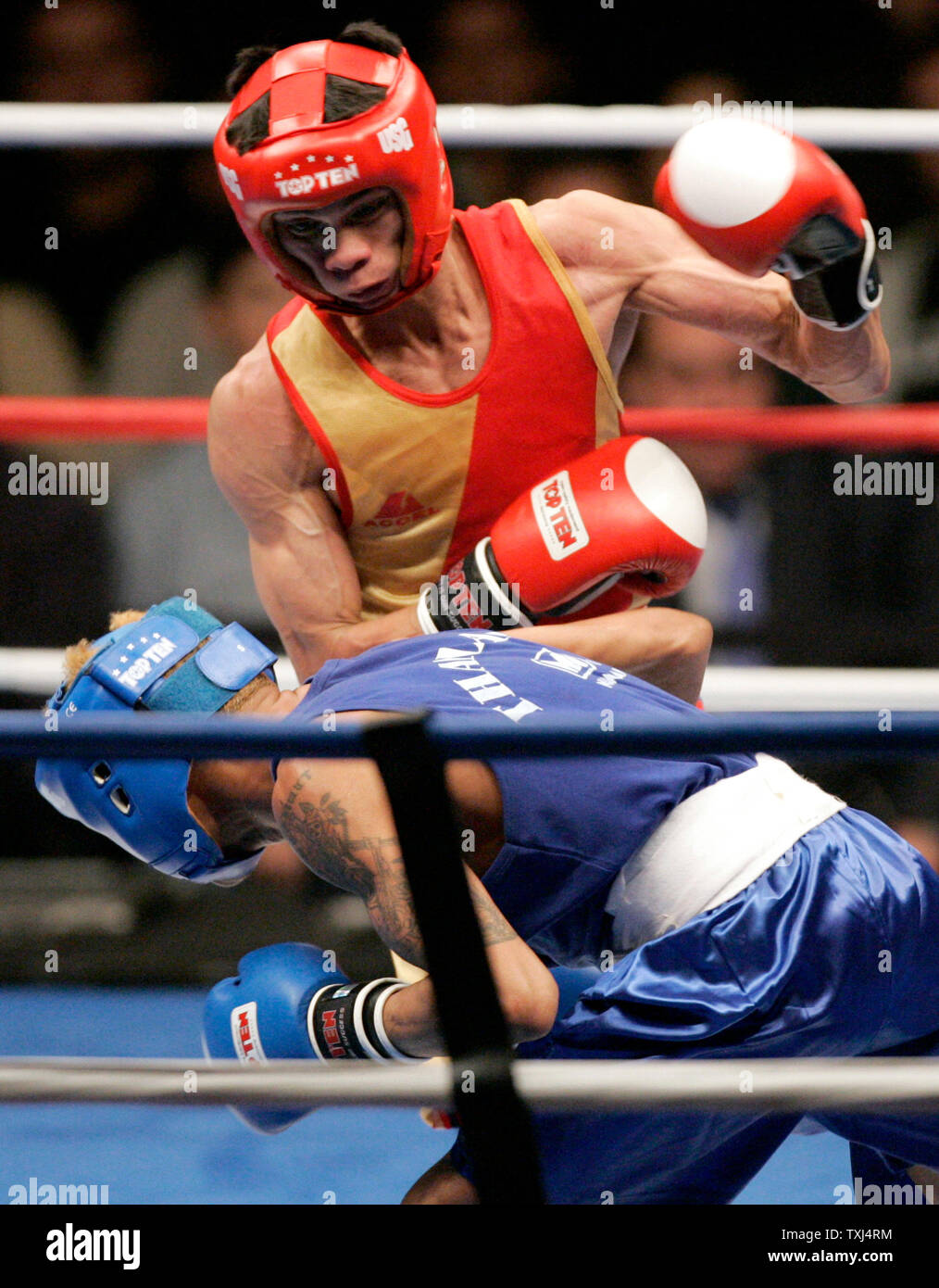 Harry Tanamor of the Philipines, in red, draws back to punch Amnat ...