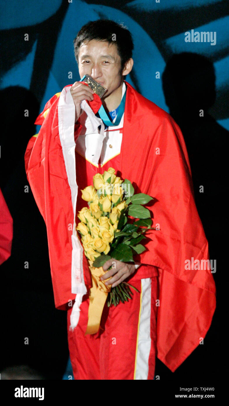 Shiming Zou of China kisses the gold medal after winning the 48kg ...