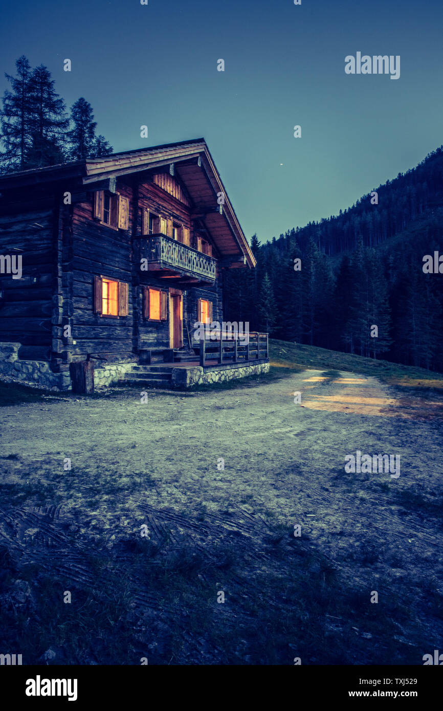 Rustic wooden farm hut in the night. European alps, Austria Stock Photo ...