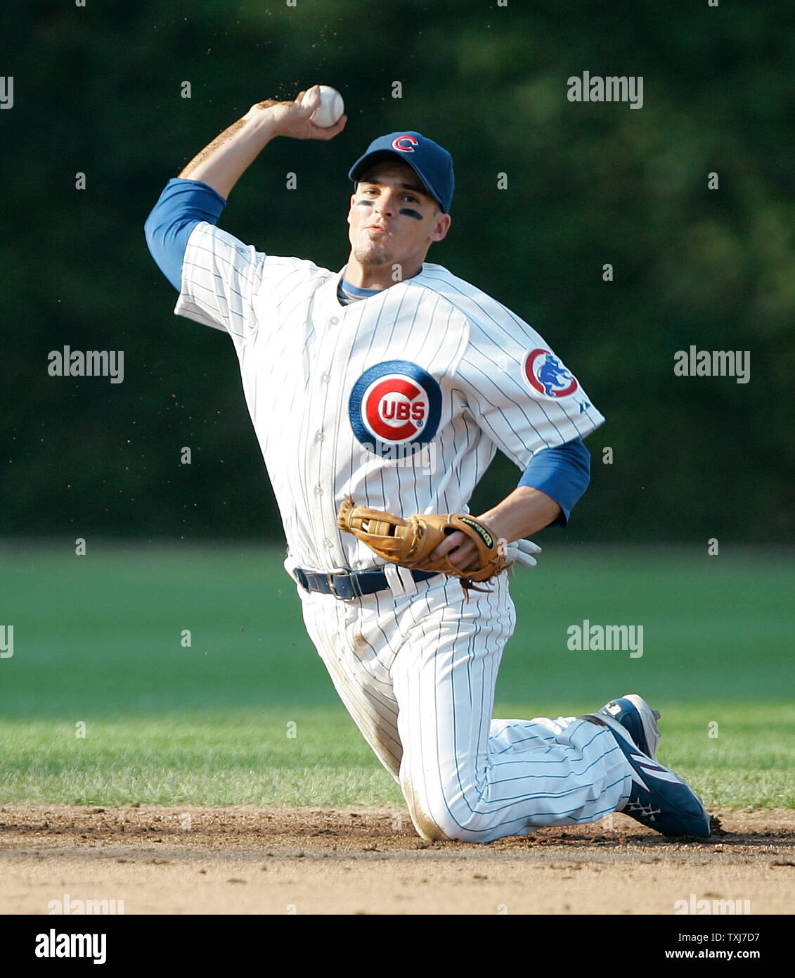 Chicago Cubs shortstop Ryan Theriot makes a throw from his knees to ...