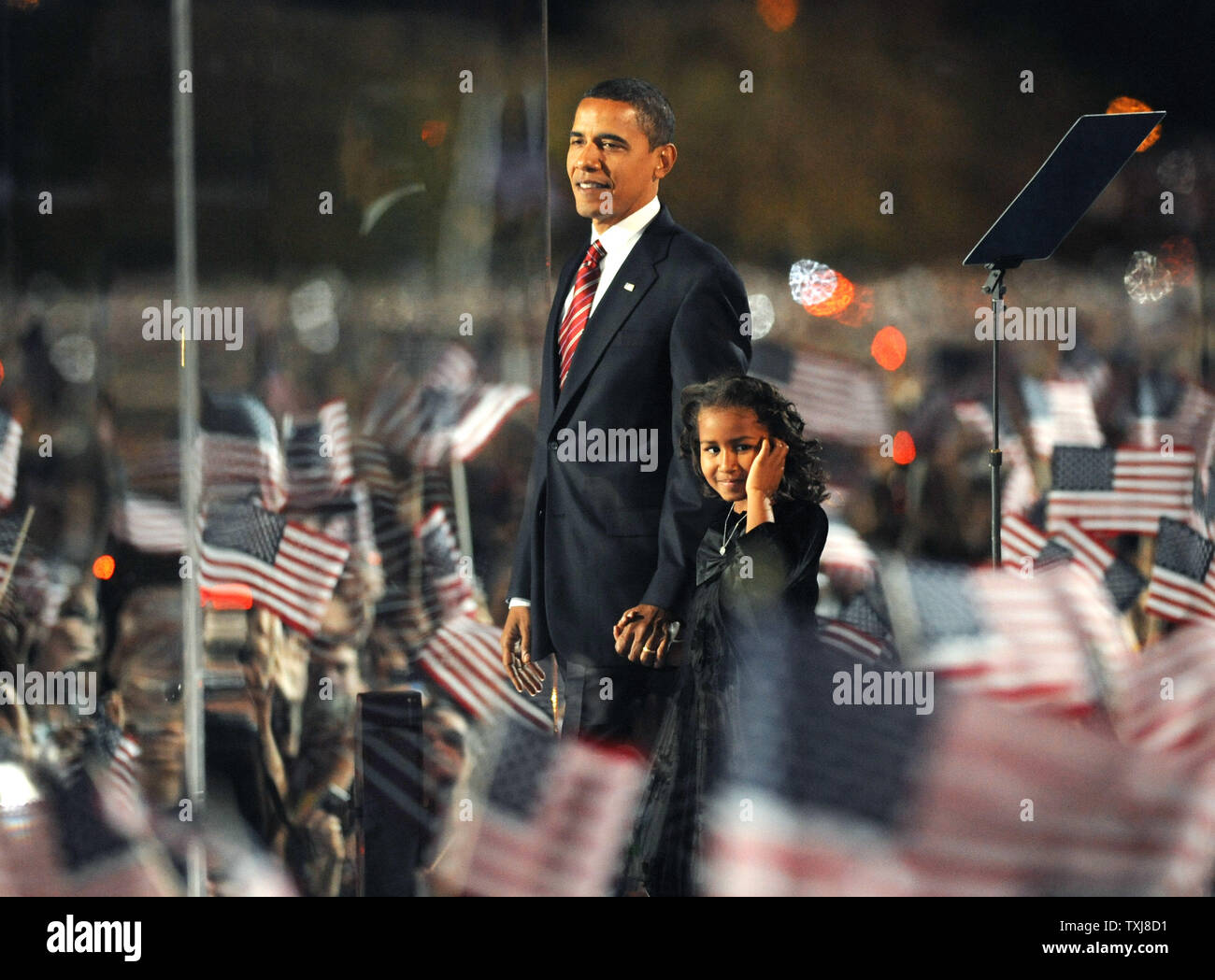 President-elect Barack Obama holds the hand of his daughter Sasha ...