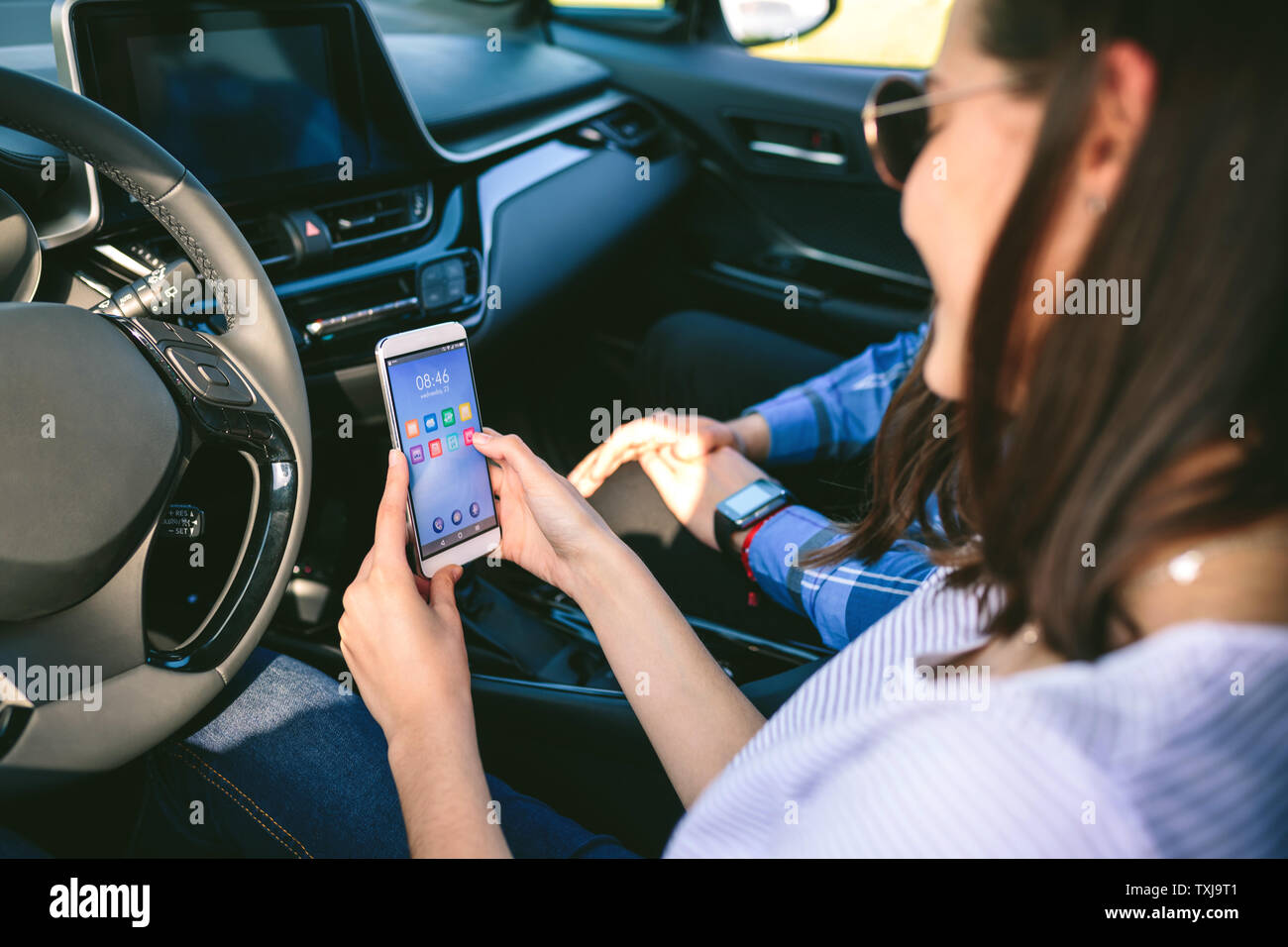 Girl and boyfriend using mobile in the car Stock Photo - Alamy