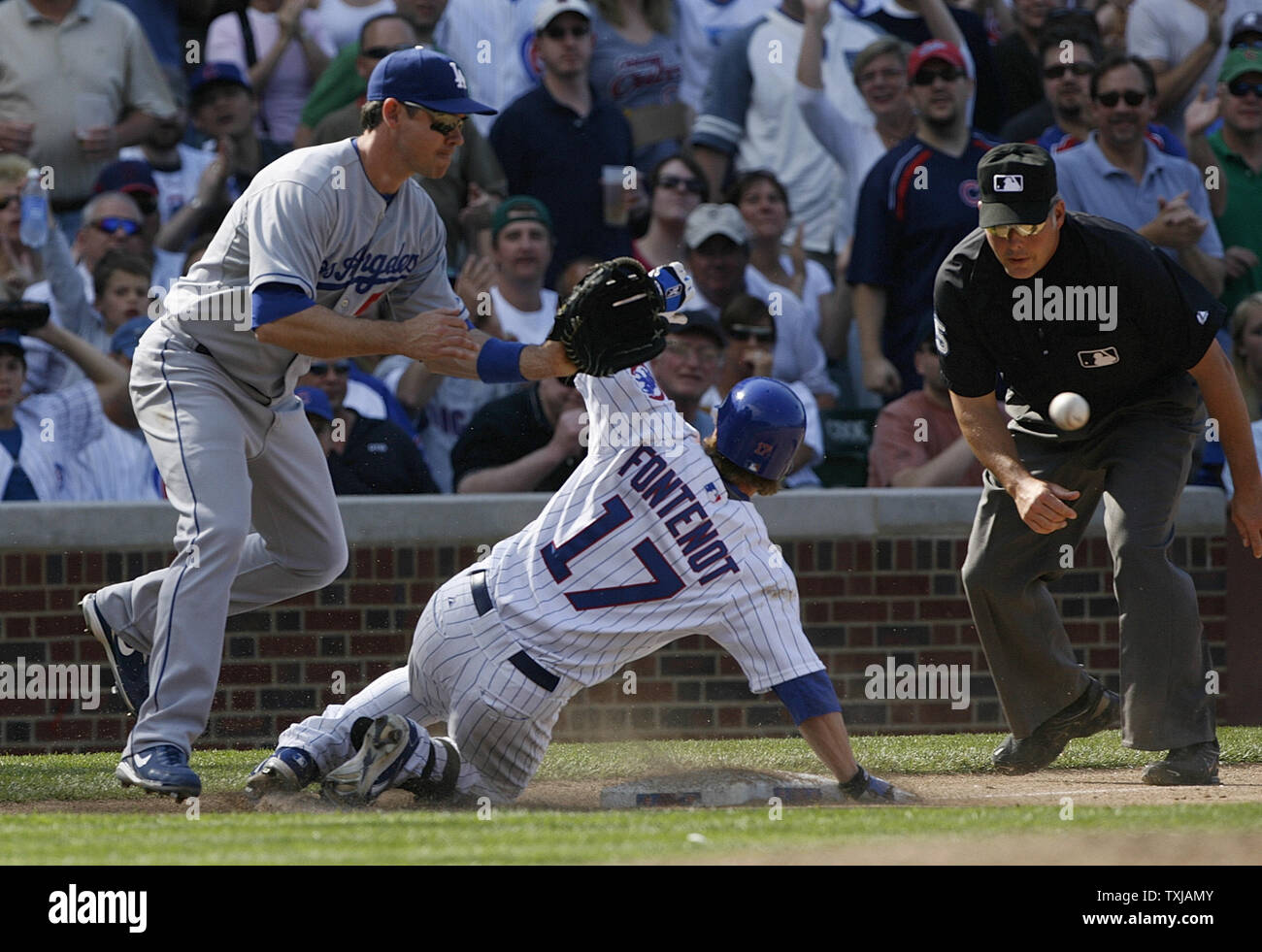 Chicago Cubs' Mike Fontenot (C) slides safely into third base with an ...