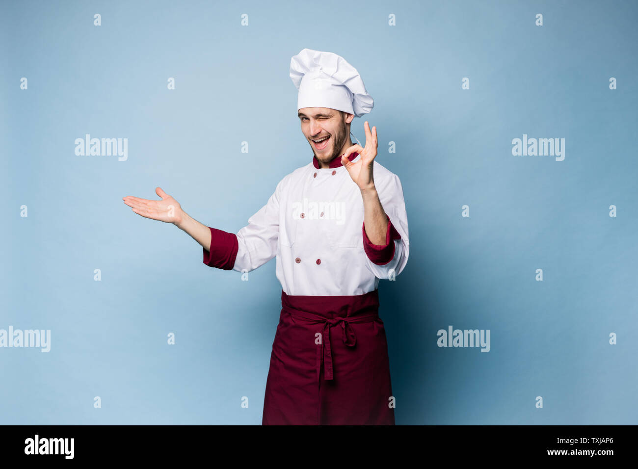 Positive professional happy man chef showing tasty ok sign isolated on ...