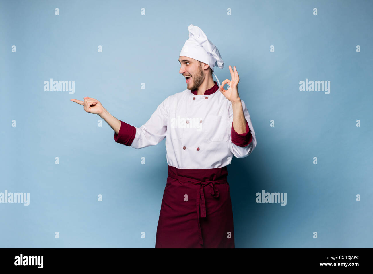 Positive professional happy man chef showing tasty ok sign isolated on ...