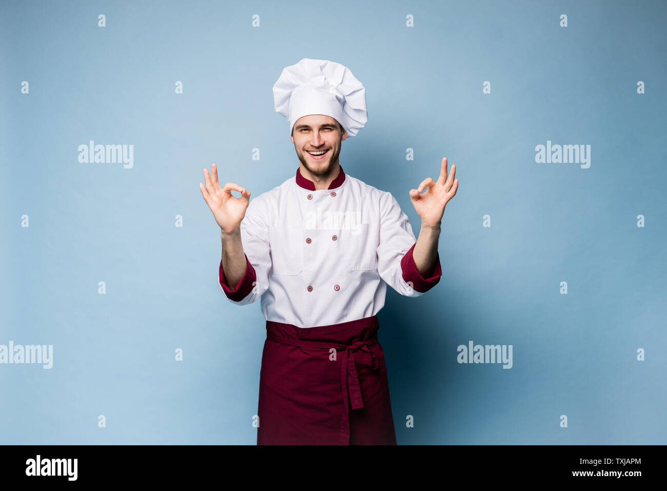 Positive professional happy man chef showing tasty ok sign isolated on ...