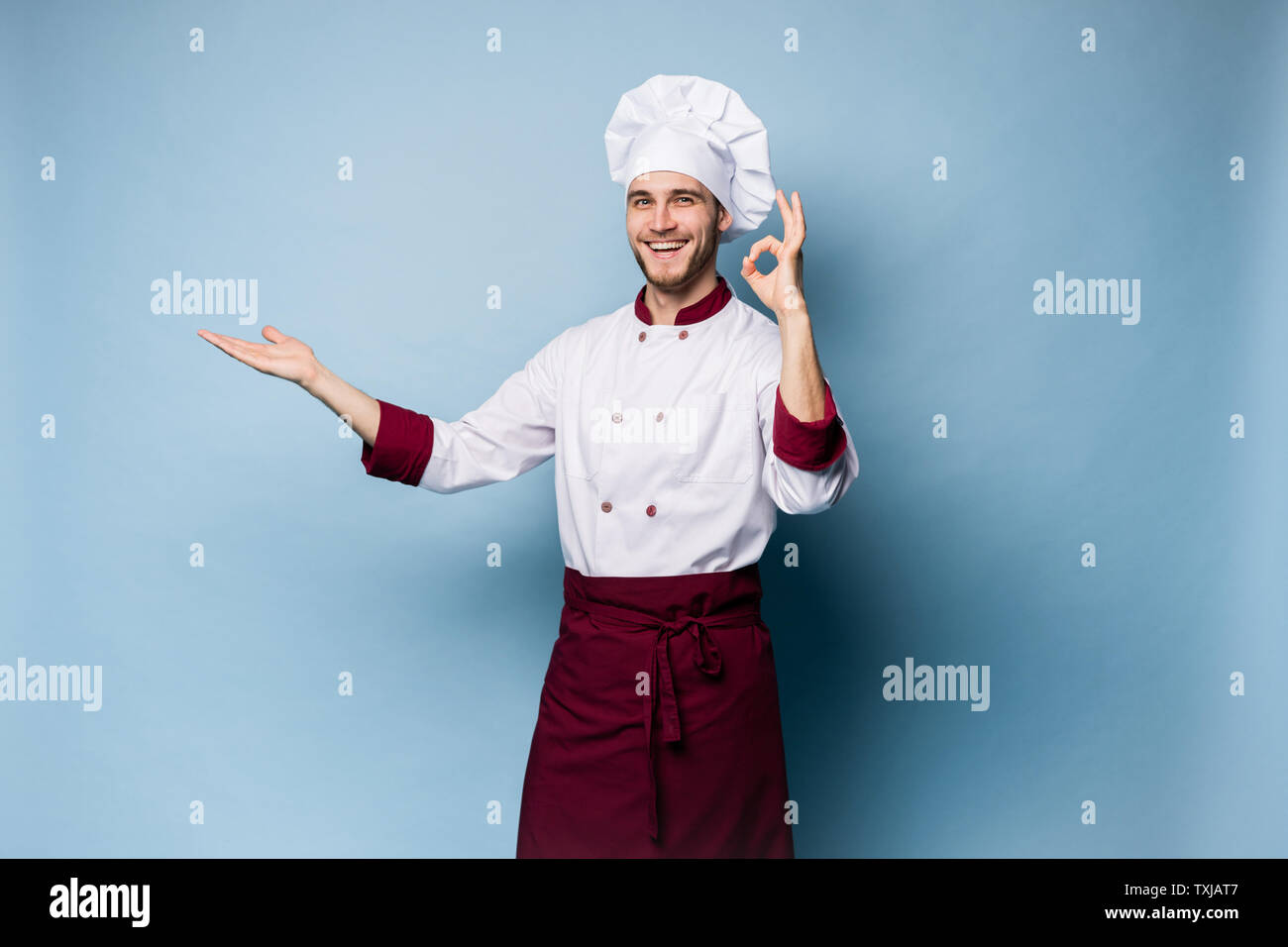 Positive professional happy man chef showing tasty ok sign isolated on ...