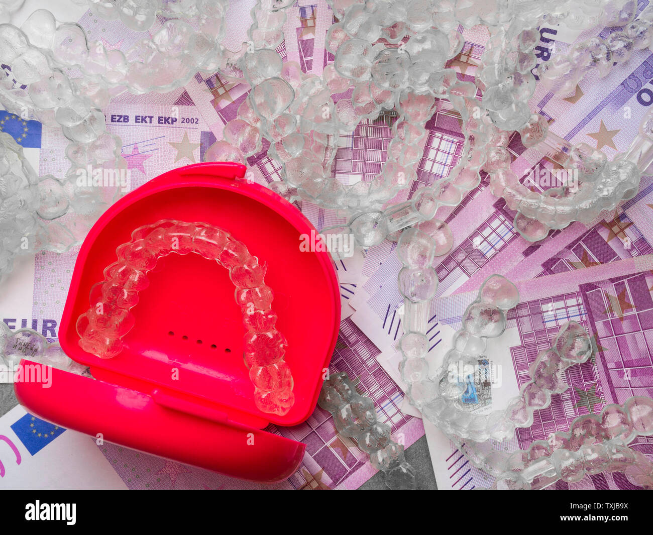 teeth braces or retainer in container isolated on cash money, costs ...