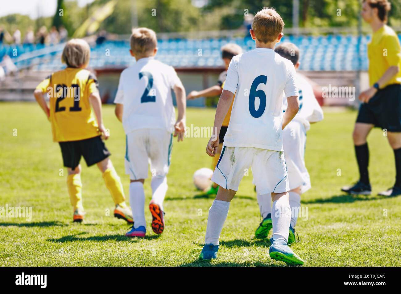 A mixed-gender soccer team playing a football match. Junior soccer ...
