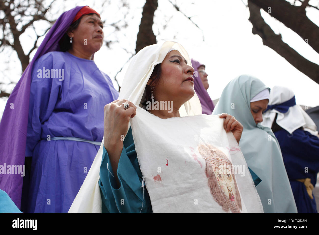Maricela Jimenez (C) plays Veronica and holds up a cloth with the image ...