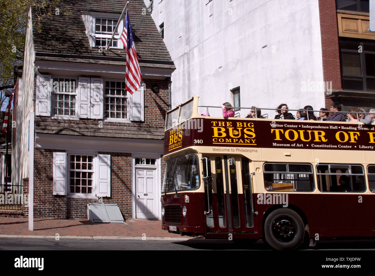 Tourists in the Big Bus double-decker vehicle passing in front of Betsy ...