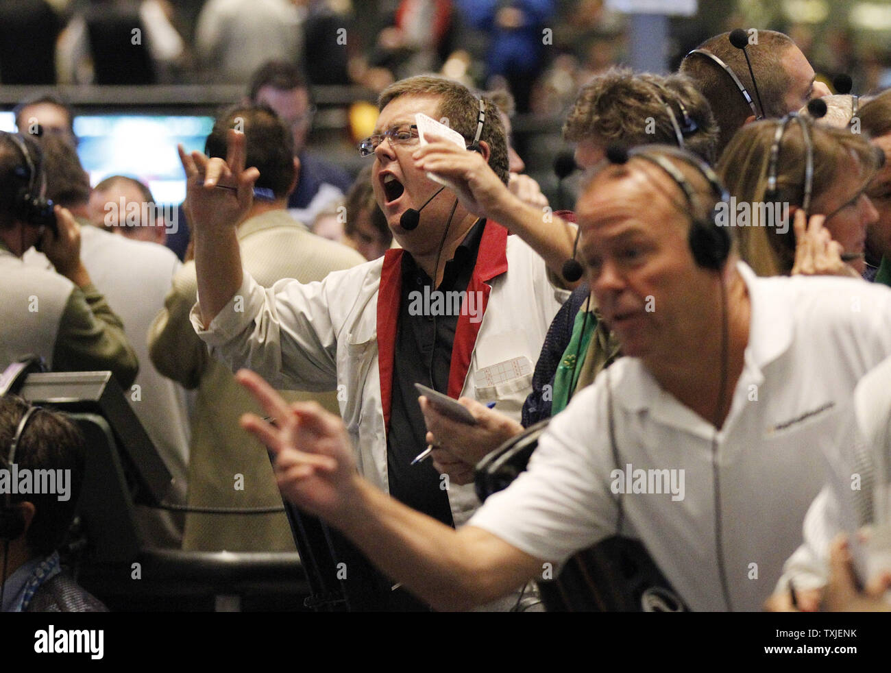 Traders work in the 10-year bond options pit at the CME Group in ...