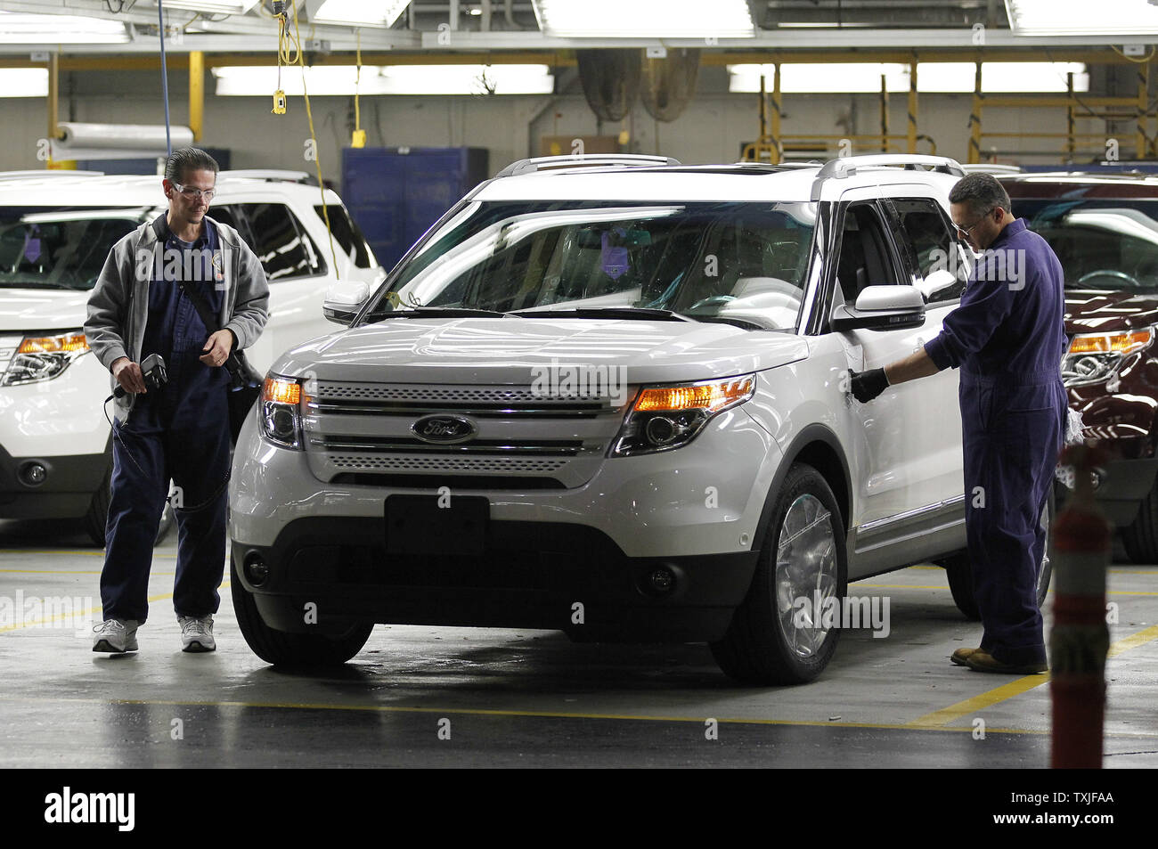 Workers inspect a Ford Explorer at Ford's Chicago Assembly Plant on ...