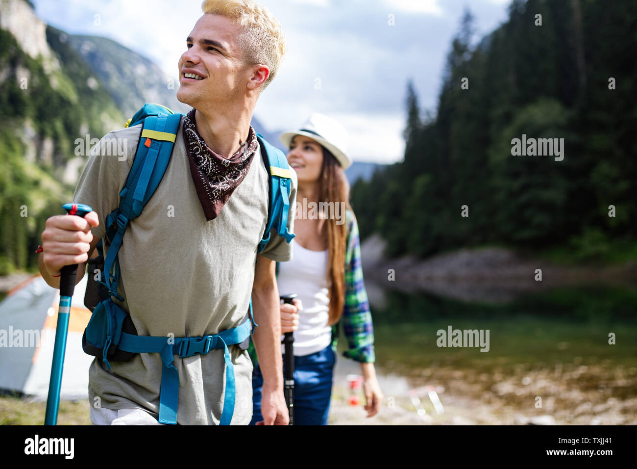 Hiking with friends is so fun. Group of young people with backpacks ...