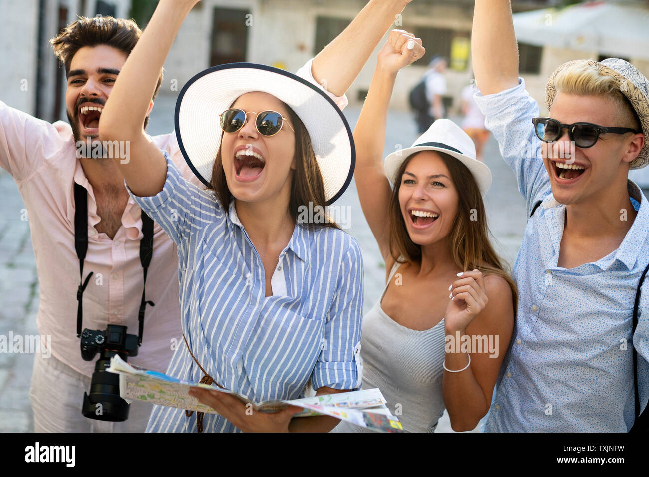Happy group of tourists traveling and sightseeing together at summer ...