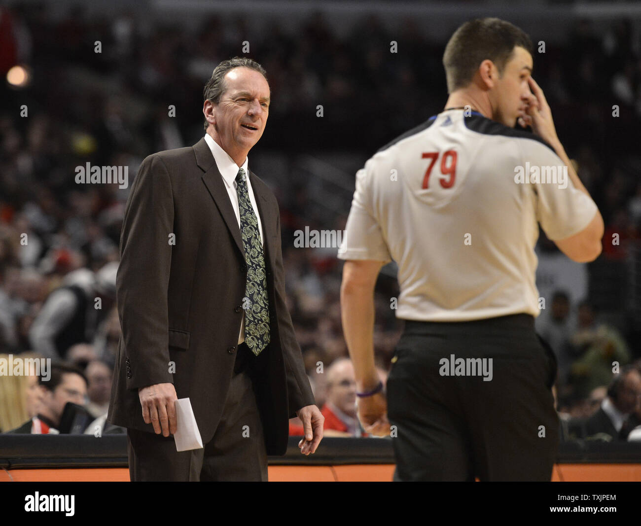 Milwaukee Bucks head coach Jim Boylan (L) questions referee Kevin Scott ...