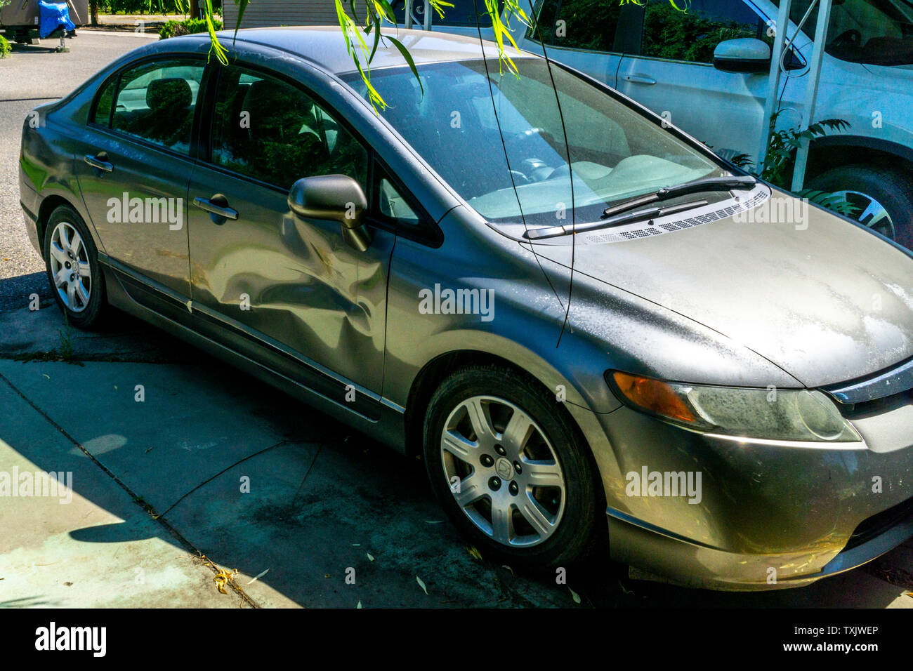 A 2007 Honda Civic with deteriorated painted and dented door Stock ...