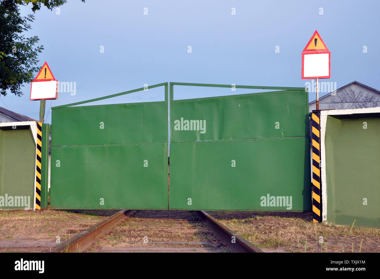 Metal gates on the railroad tracks. Entrance to the production area ...
