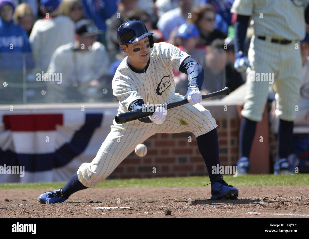 Chicago Cubs' Darwin Barney lays down a squeeze bunt scoring Mike Olt ...