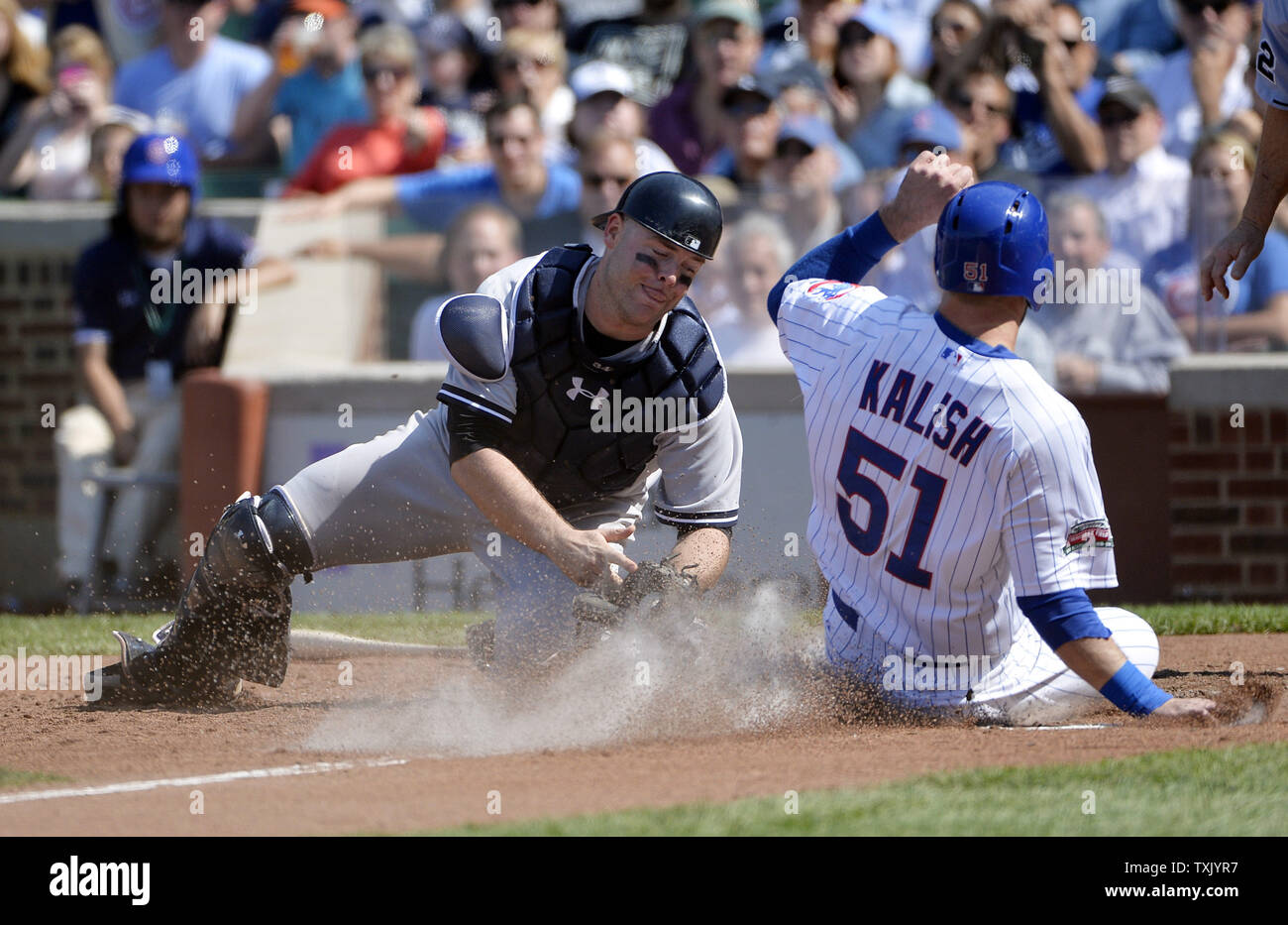 Chicago Cubs' Ryan Kalish scores past New York Yankees catcher Brian McCann during the seventh ...