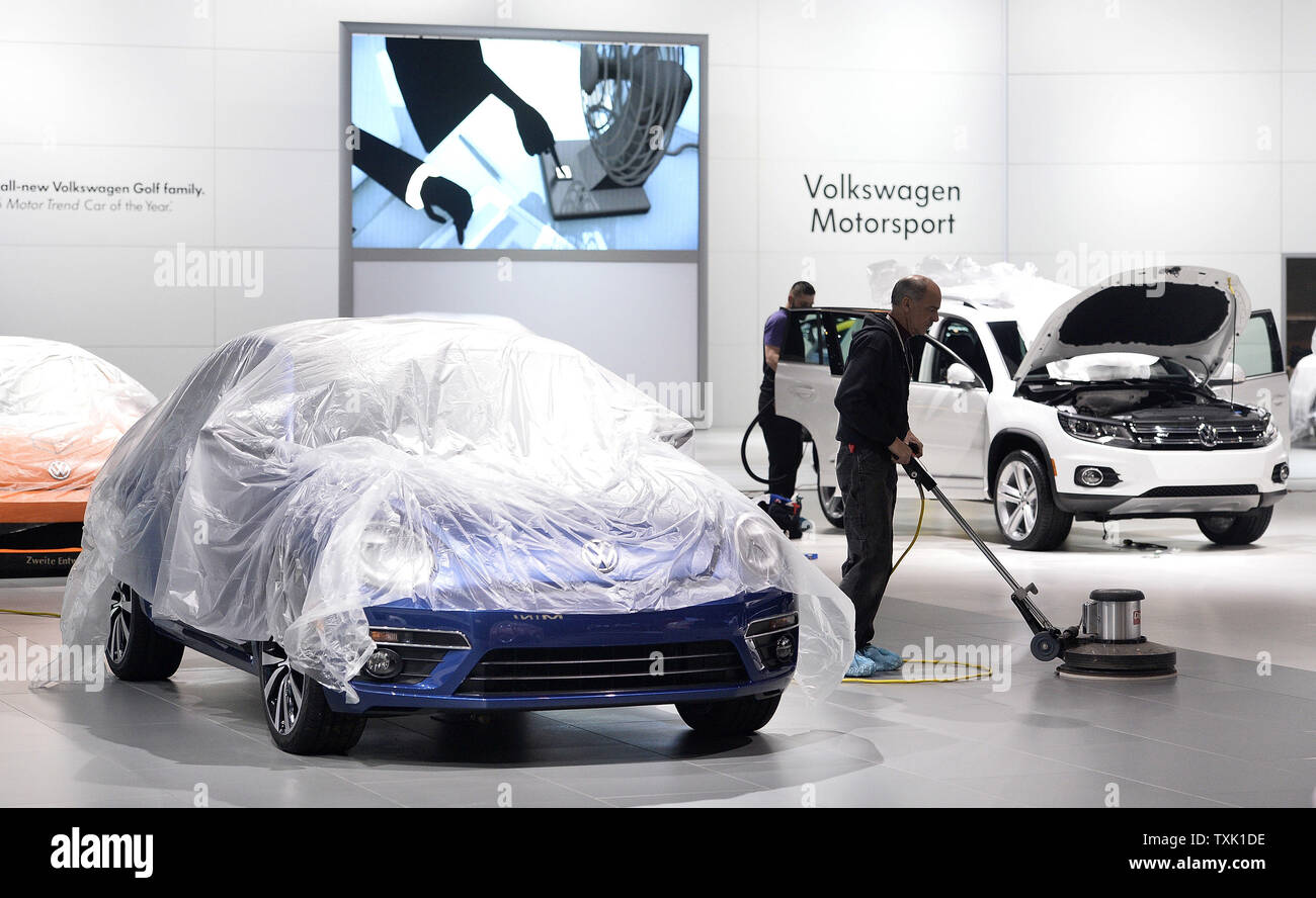 A worker buffs the floor at the Volkswagen exhibit at the Chicago Auto ...