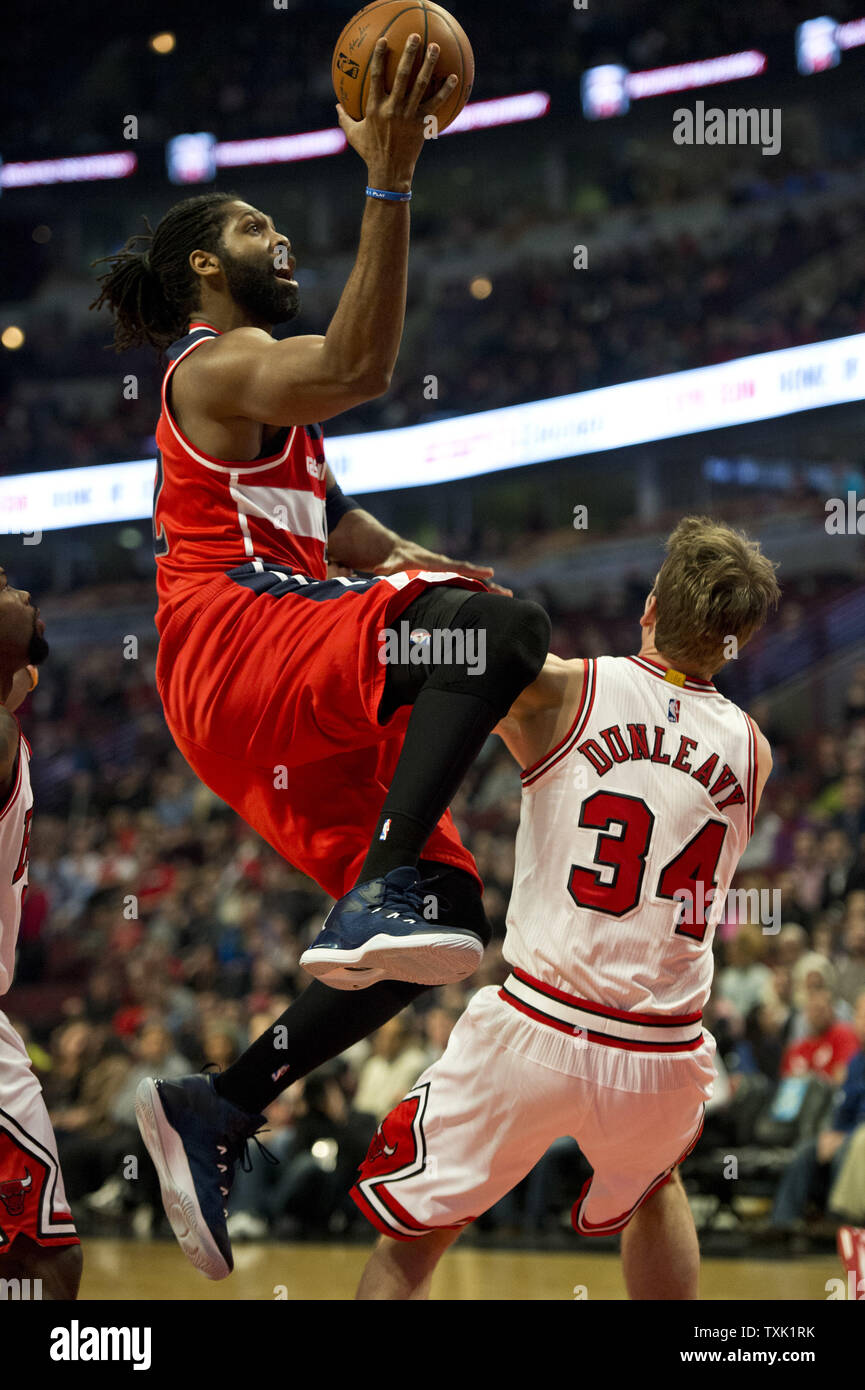 Washington Wizards forward Nene Hilario (L) drives on Chicago Bulls forward Mike Dunleavy during ...