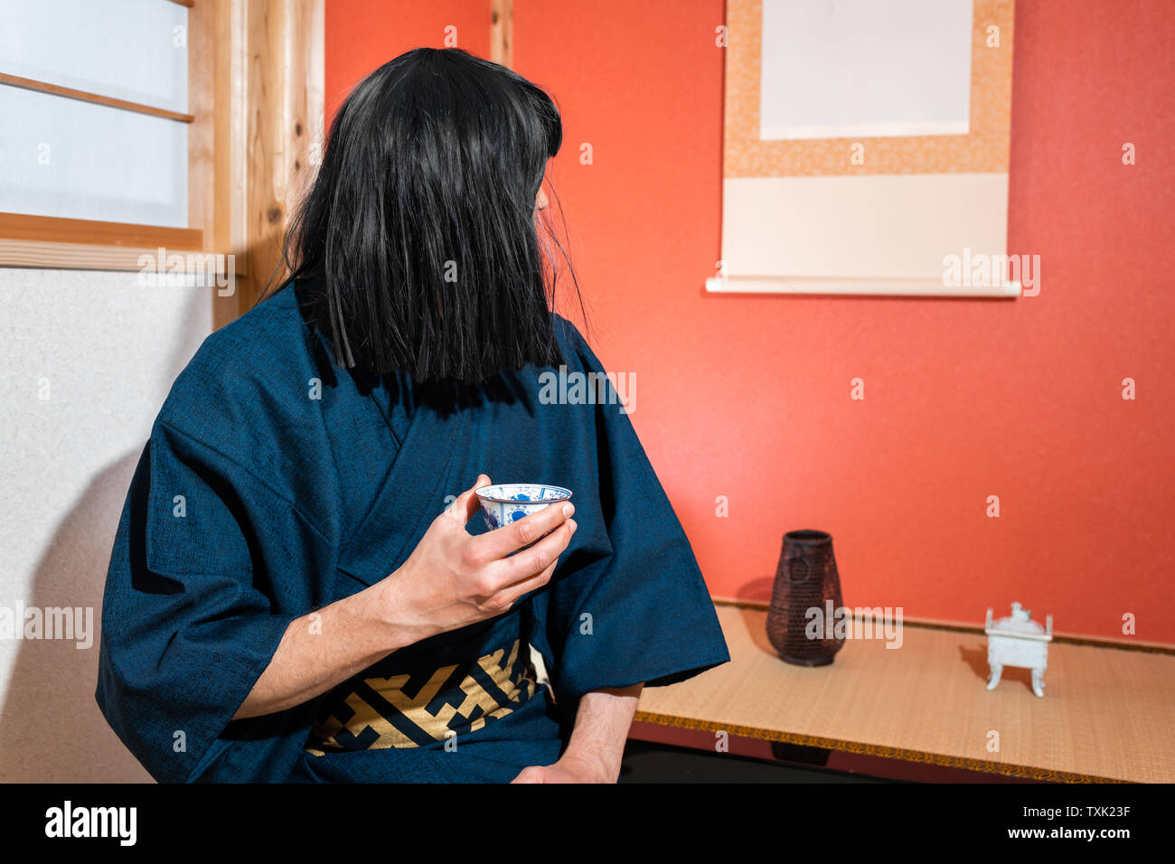 Traditional japanese man in kimono costume and black hair sitting by ...