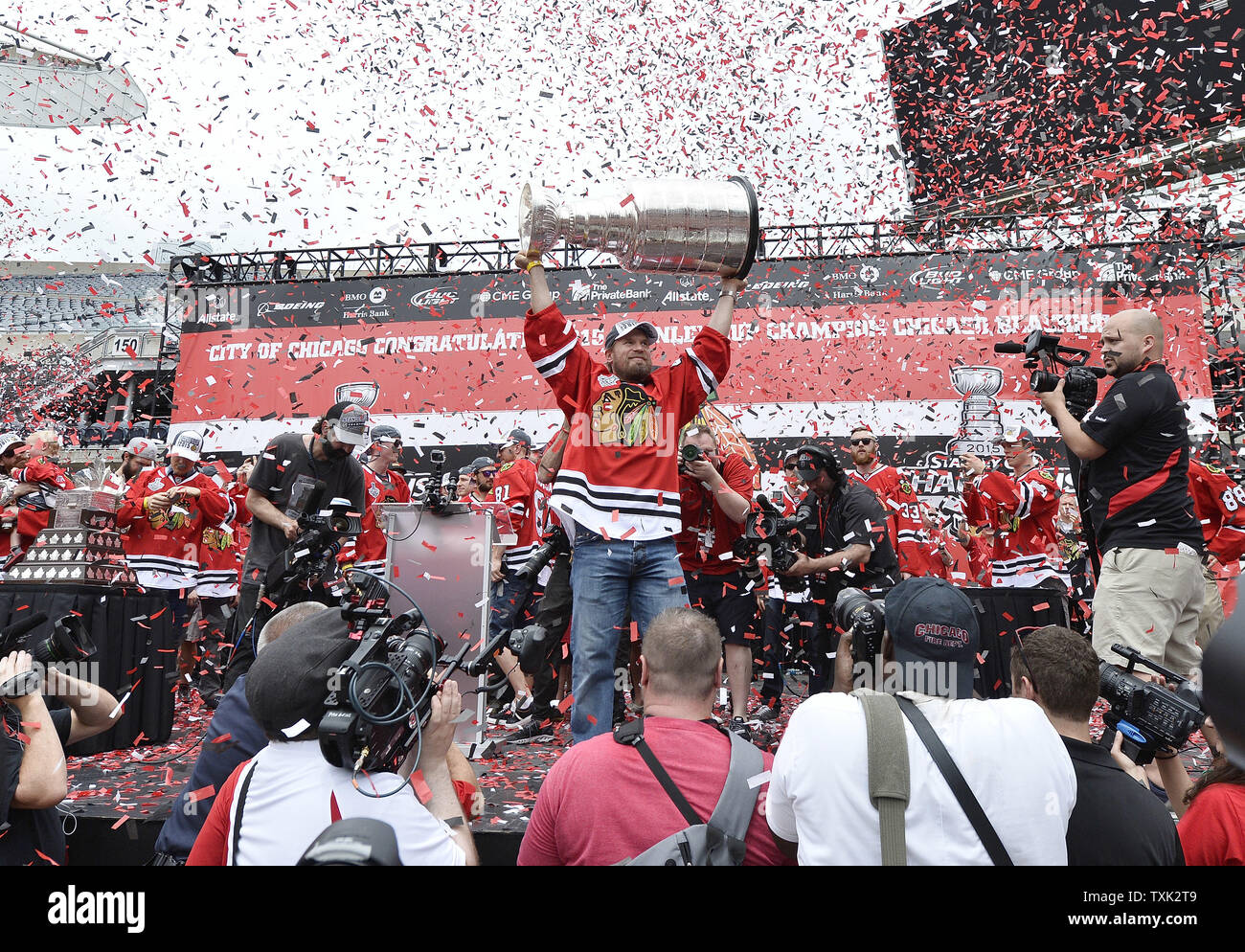 Chicago Blackhawks' Kimmo Timonen hoists the Stanley Cup at a rally at ...