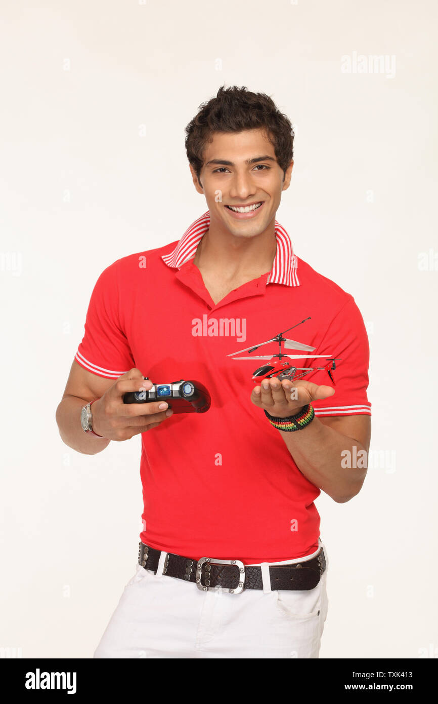 Man with remote control and model helicopter Stock Photo - Alamy