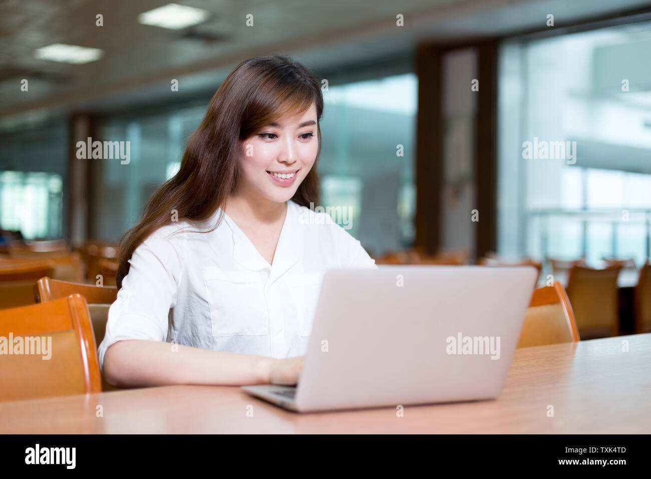 Asian beautiful female student study in library with laptop Stock Photo ...