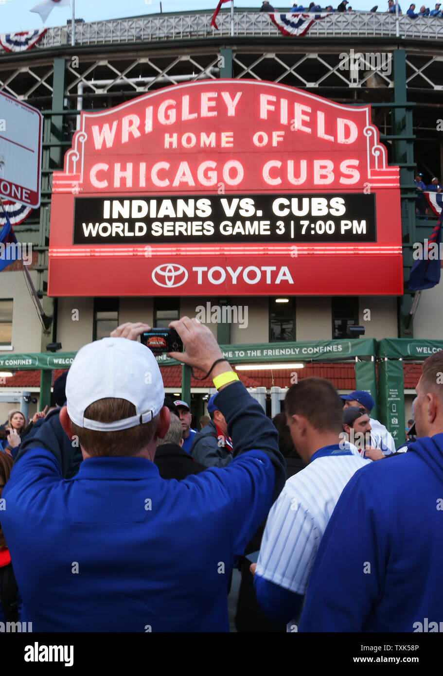 A fan photographs the main Wrigley Field sign before the start of the ...