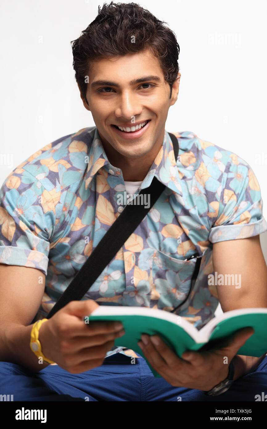 College student reading a book Stock Photo - Alamy