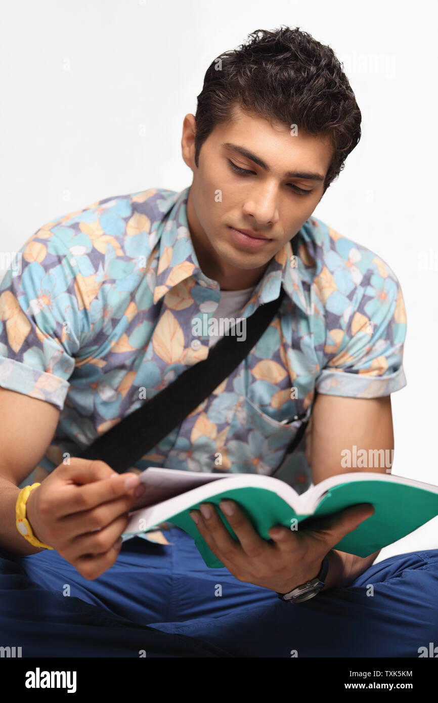 College student reading a book Stock Photo - Alamy