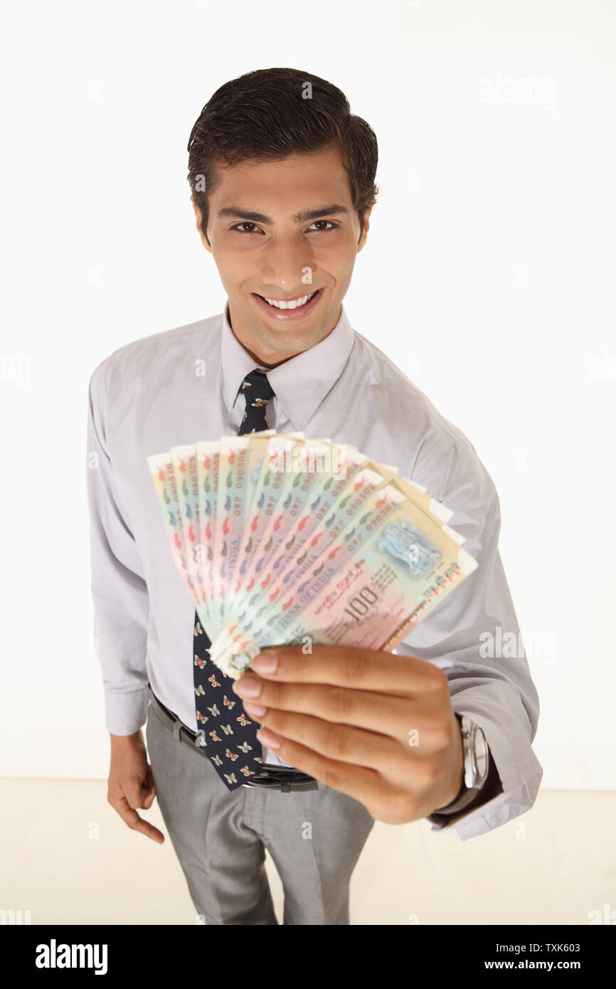 Portrait of a businessman showing banknotes Stock Photo - Alamy