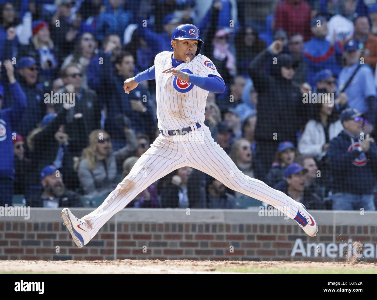 Chicago Cubs shortstop Addison Russell scores against the Milwaukee ...