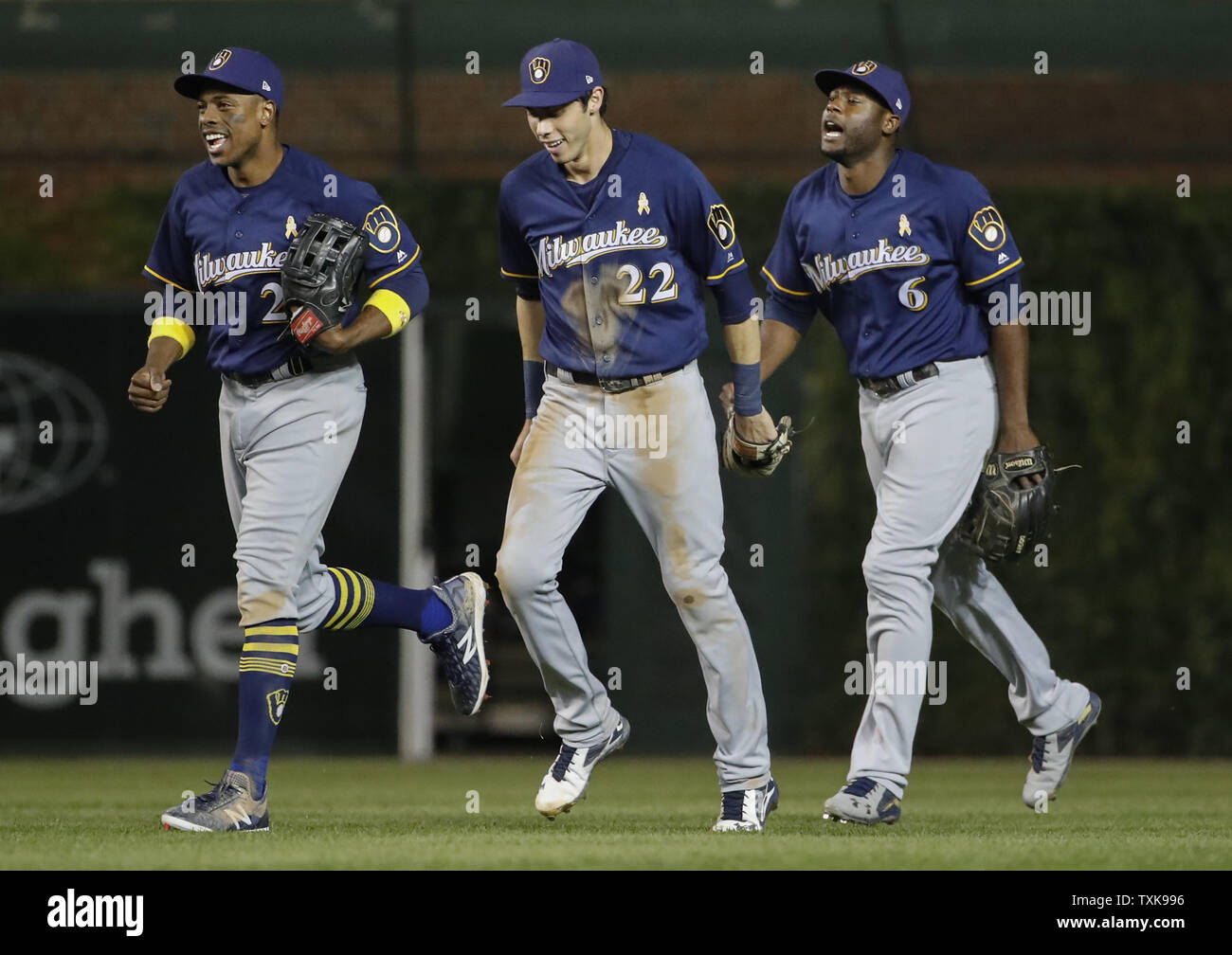 Milwaukee Brewers' Jacob Nottingham (26), Christian Yelich (22) and ...