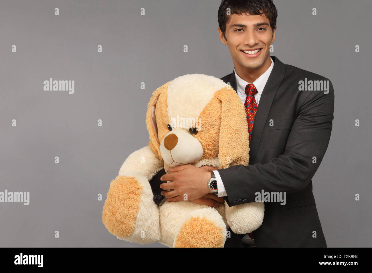 Portrait of a businessman holding a toy Stock Photo - Alamy