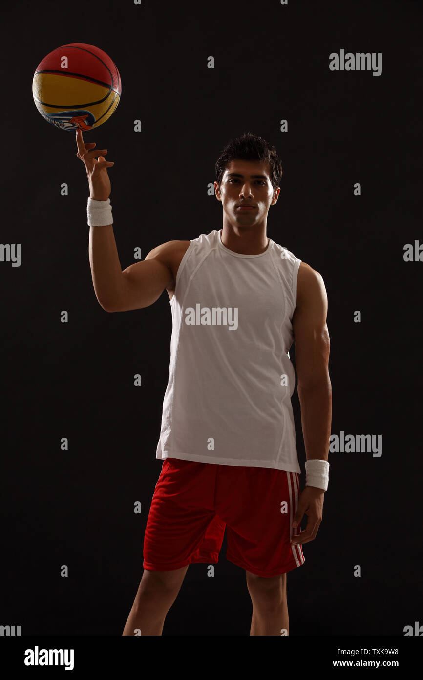 Man balancing basketball on finger Stock Photo - Alamy