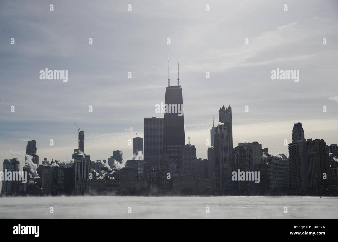Steam rises from the city buildings and Lake Michigan in Chicago on ...