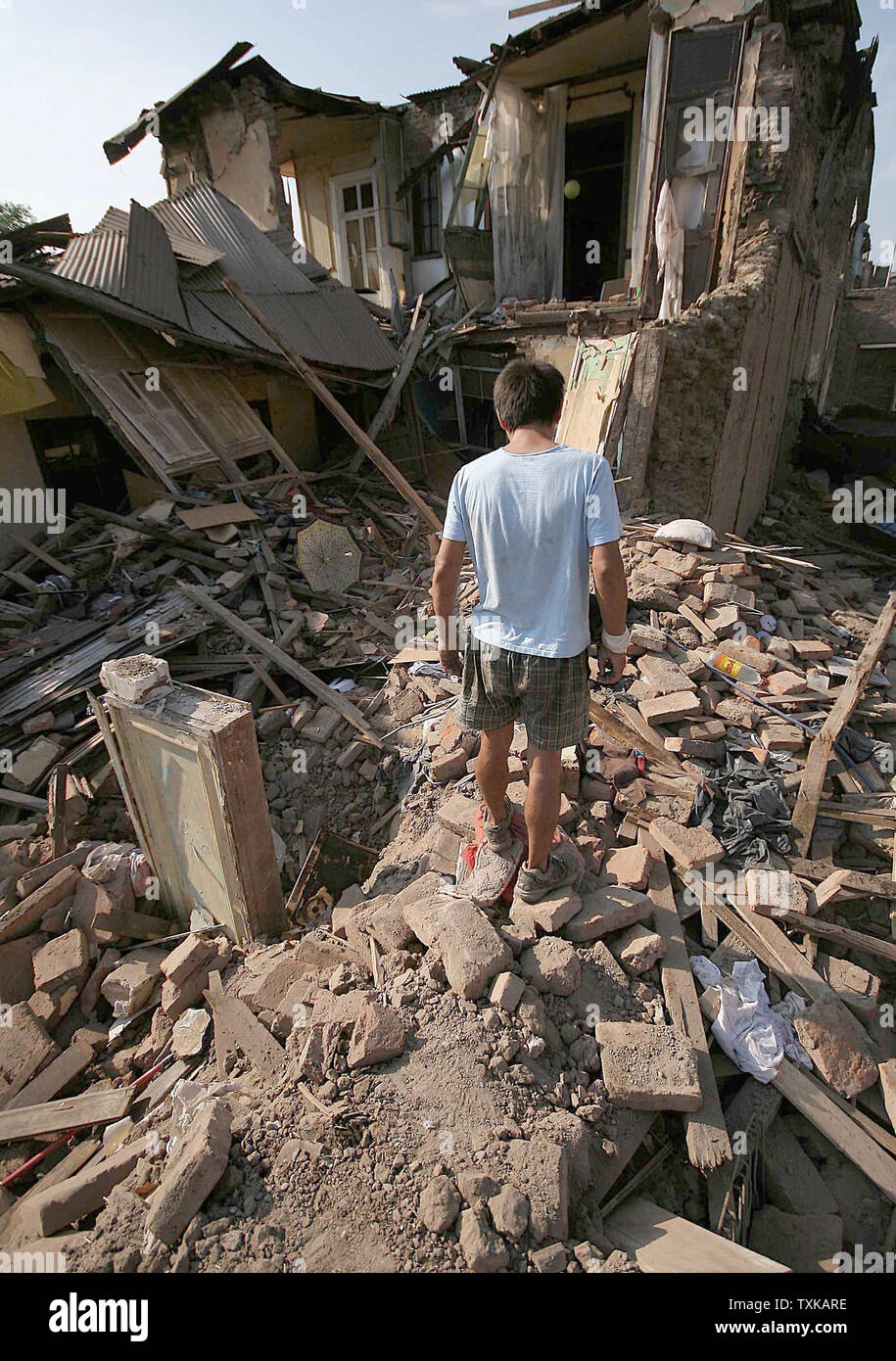 A residents surveys damage to his home in Santiago, Chile on March 1 ...