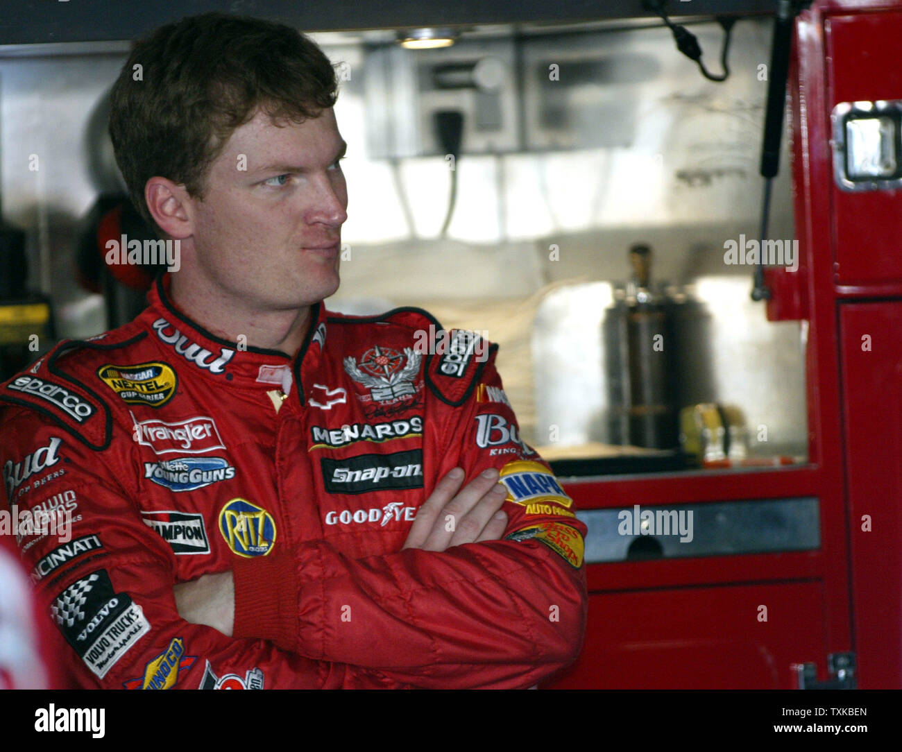 Race car driver Dale Earnhardt, Jr. waits as his team works on his race ...