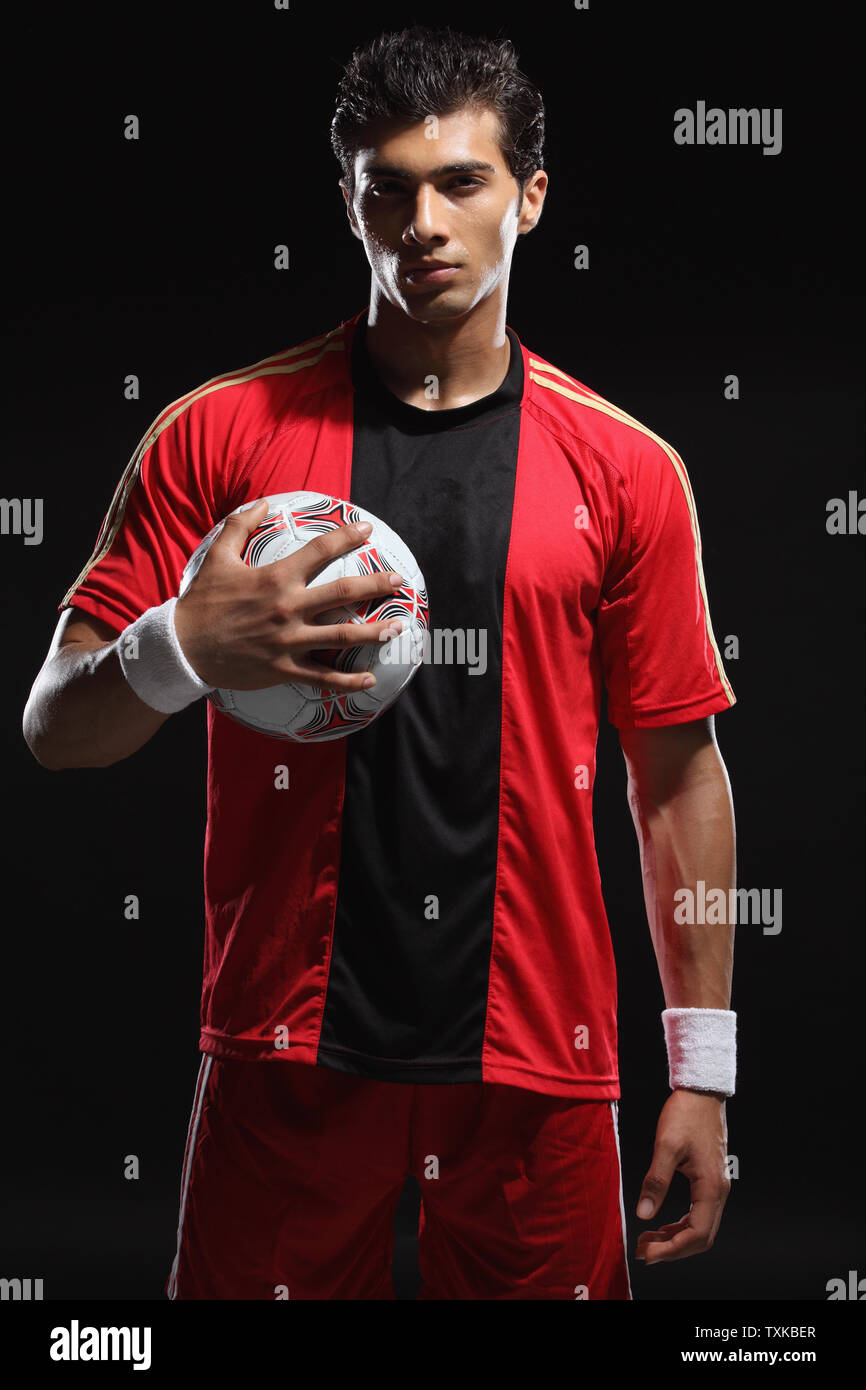 Portrait of a man holding a soccer ball Stock Photo - Alamy